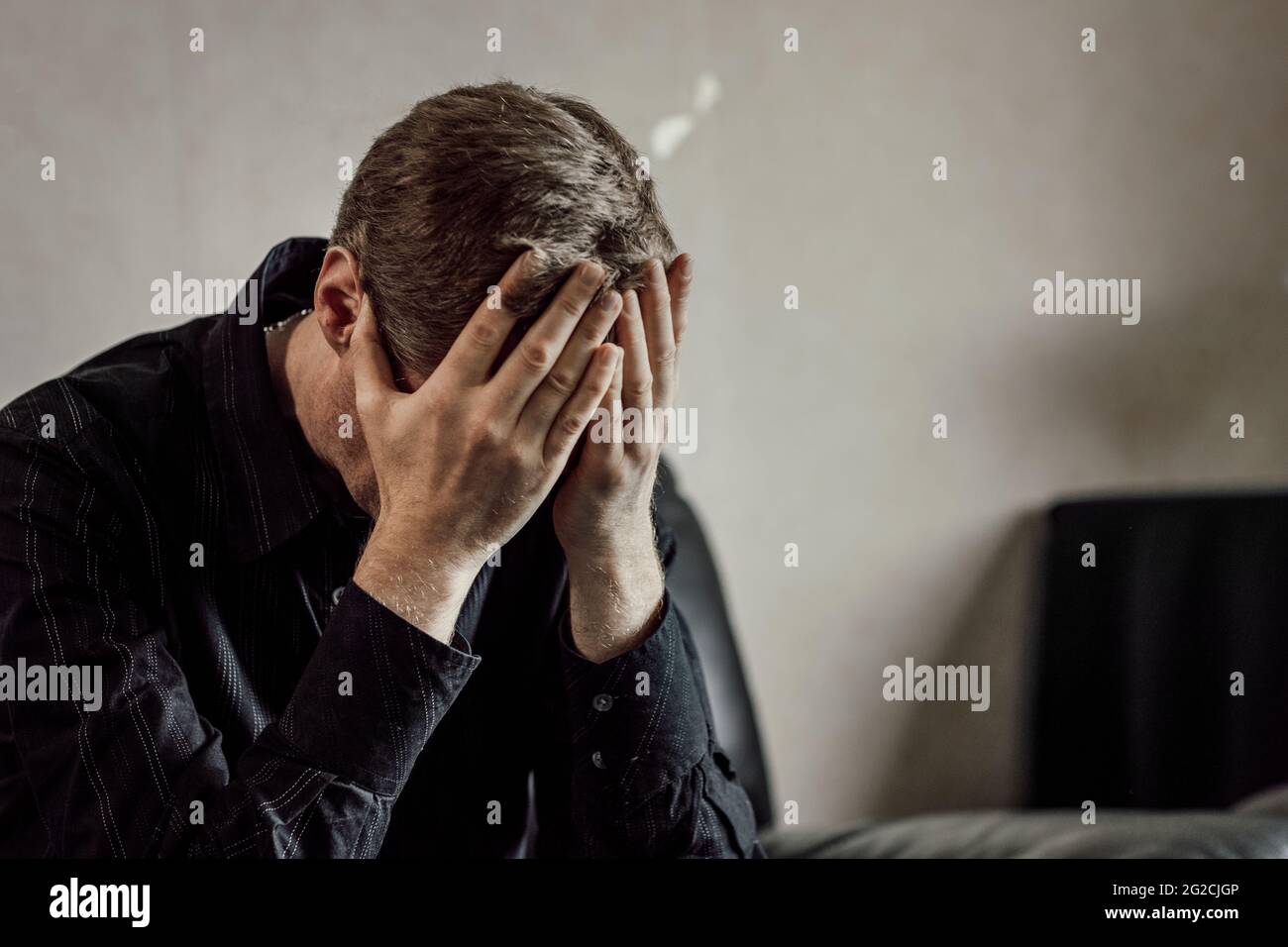 Man covering face with hands Stock Photo - Alamy