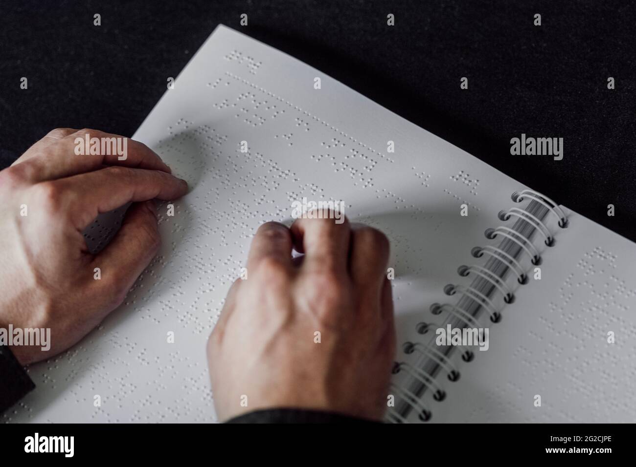 Person's hand reading braille book hi-res stock photography and images ...