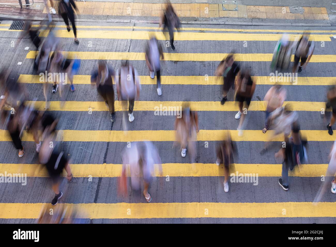 blurred Busy crowds or Commuters Crossing Street in Hong Kong, with ...