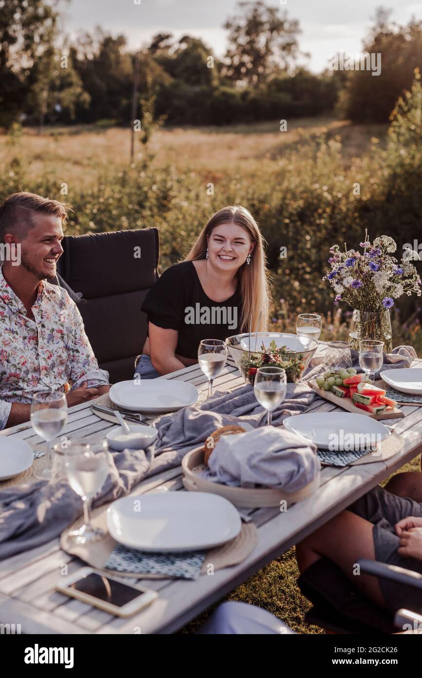 Friends during garden party Stock Photo - Alamy