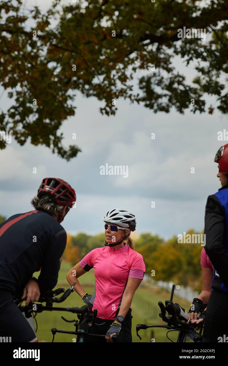 Smiling cyclists talking together Stock Photo - Alamy