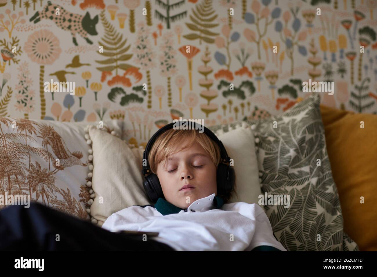 Boy lying in bed Stock Photo - Alamy