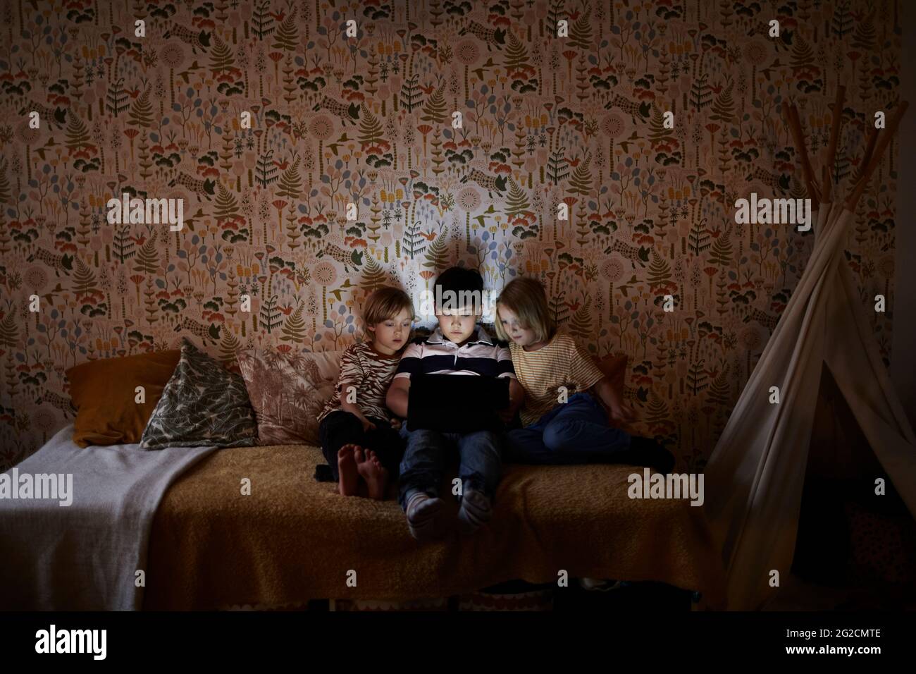 Boys using digital tablet on bed Stock Photo - Alamy
