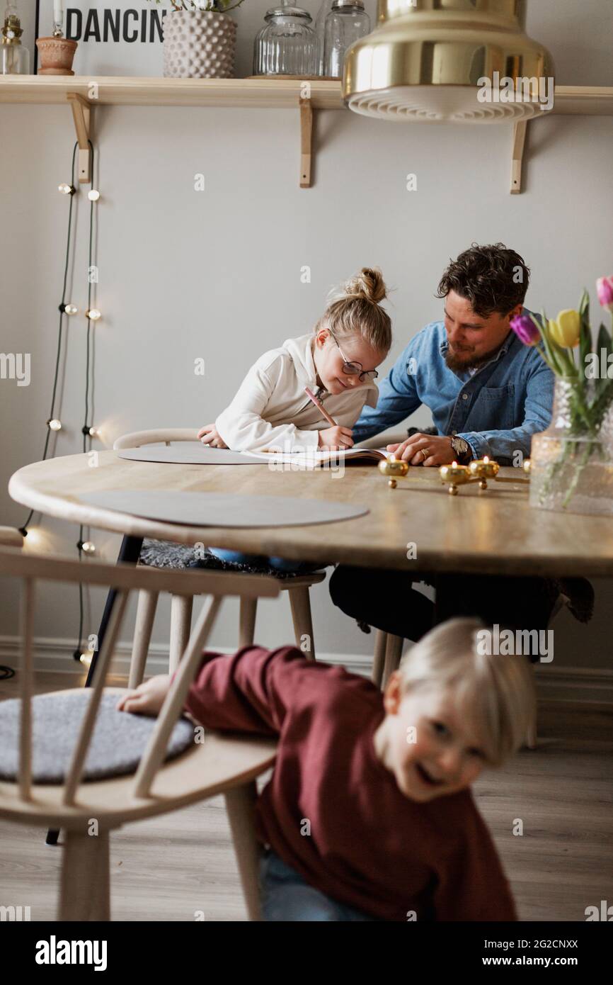 Father helping daughter doing homework Stock Photo - Alamy