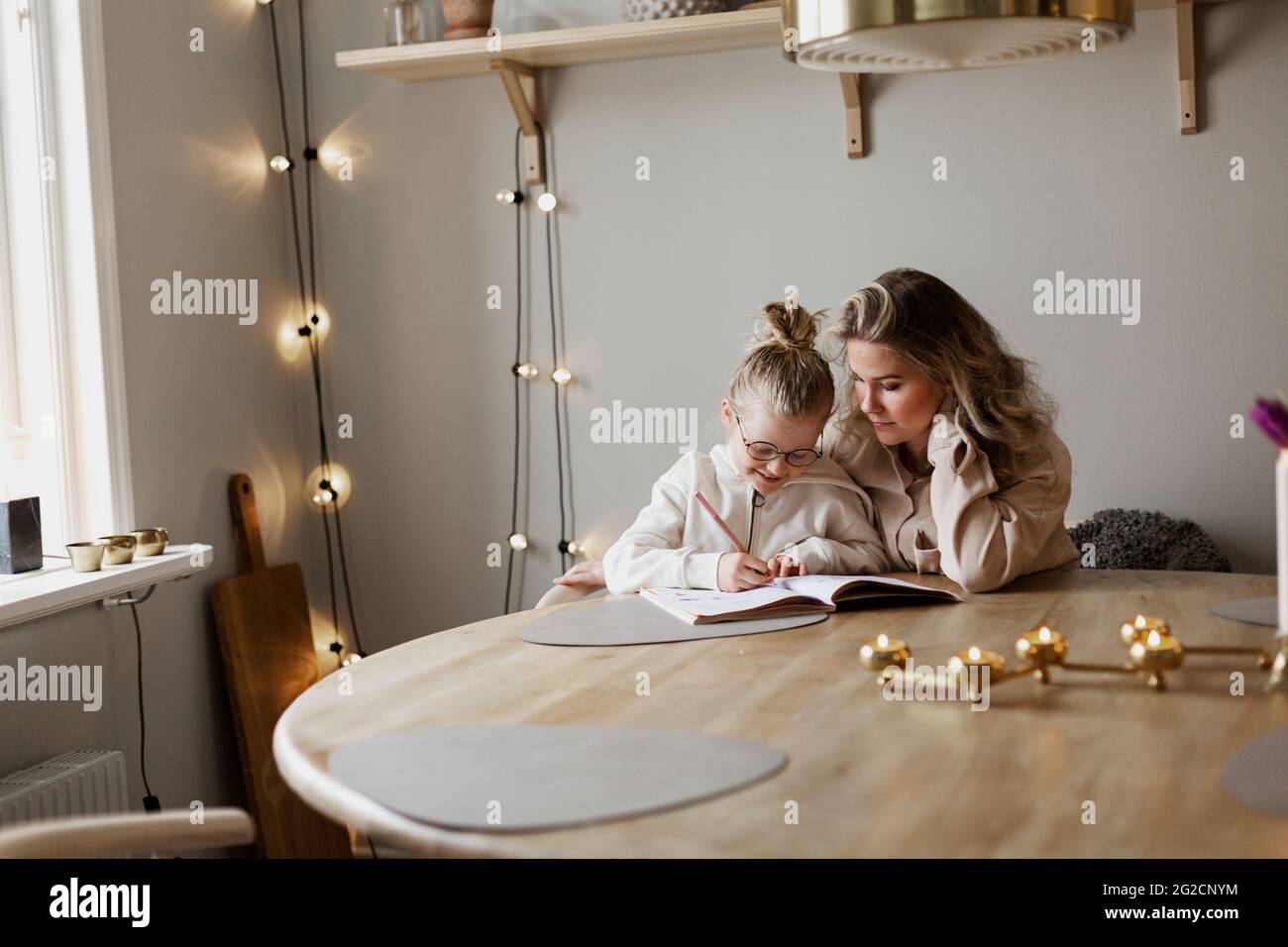 Mother and child doing homework together hi-res stock photography and ...