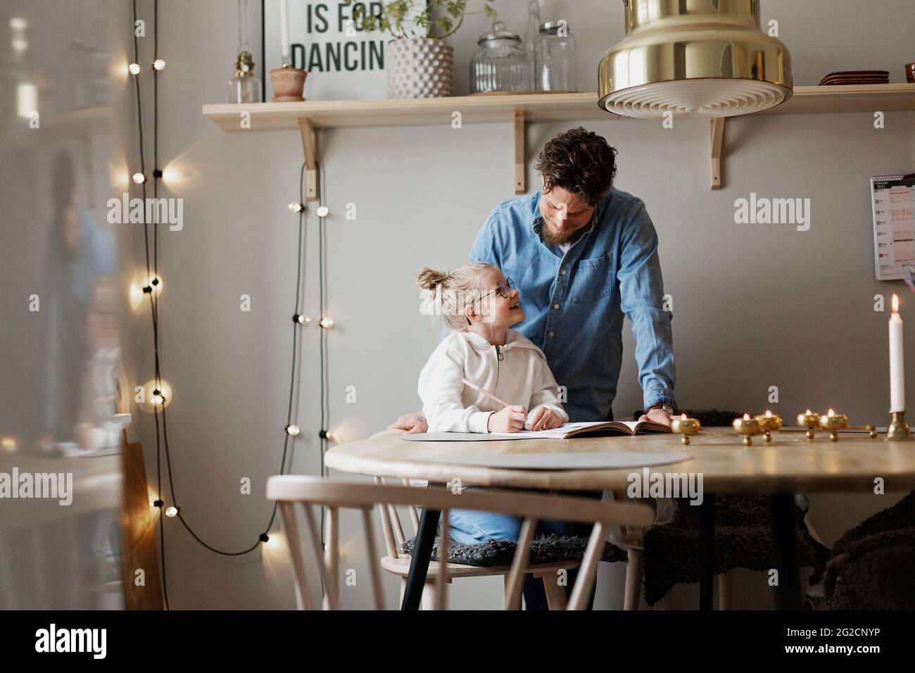 Father helping daughter doing homework Stock Photo - Alamy