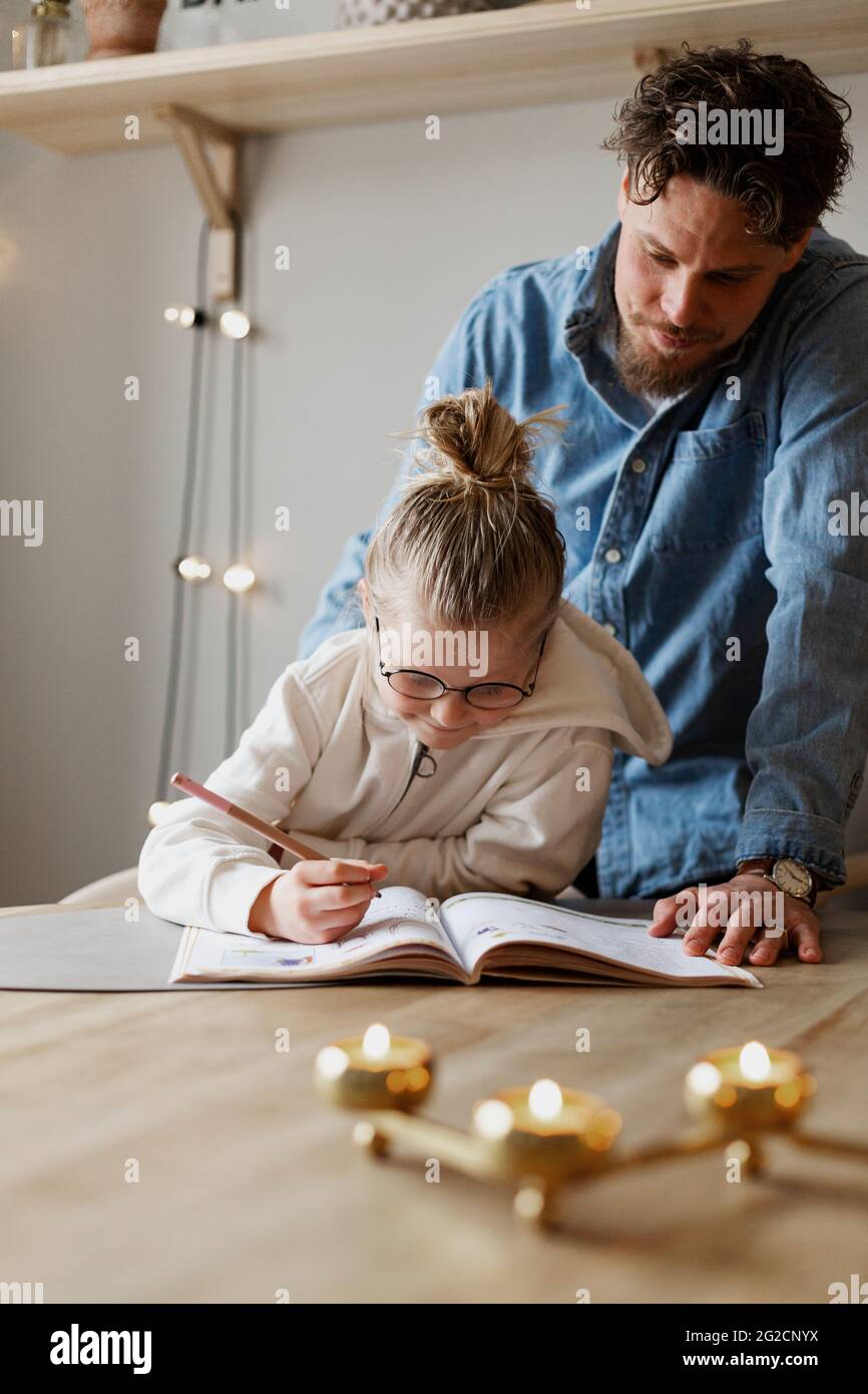 Father helping daughter doing homework Stock Photo - Alamy