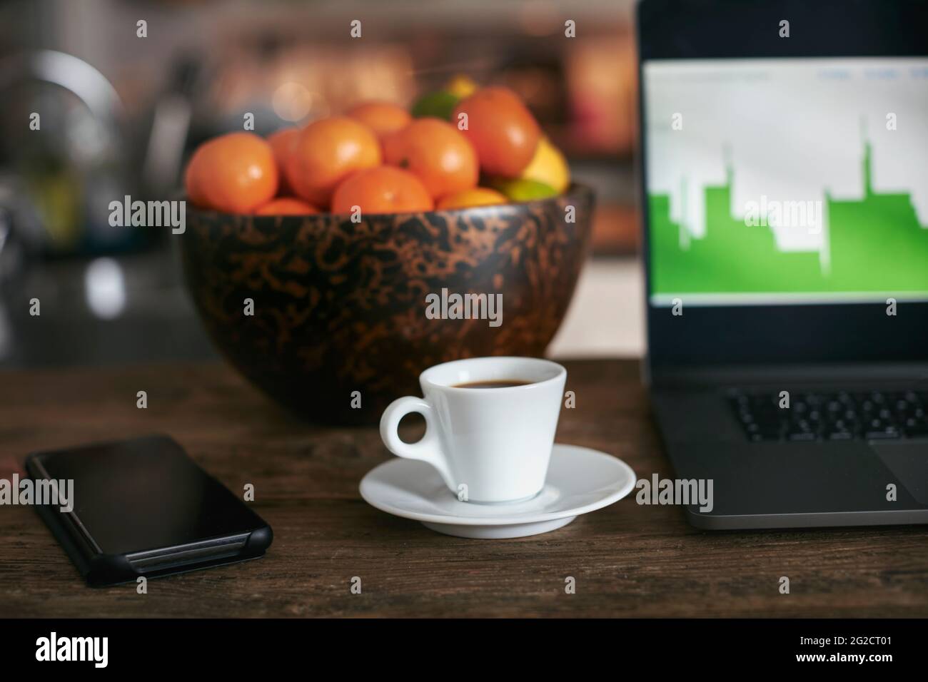 Cell phone and coffee cup on kitchen worktop Stock Photo - Alamy