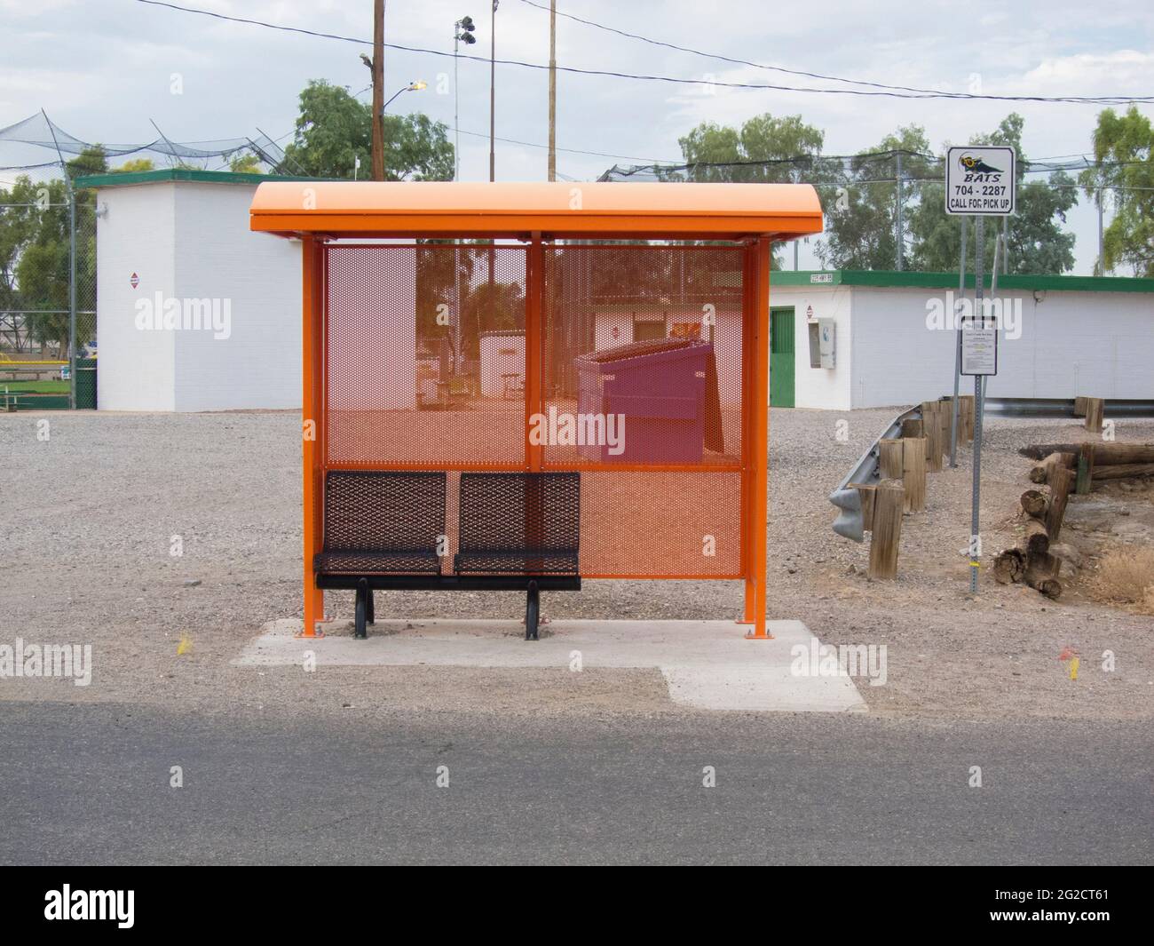 A new, orange, metal, mesh bus stop kiosk, shelter. Near Borego Springs ...