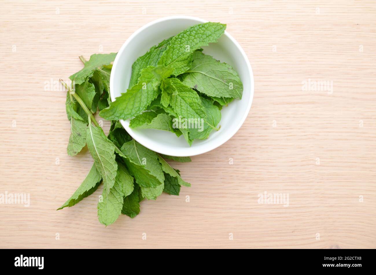 Curly mint leaves with bowl isolated on white background Stock Photo ...