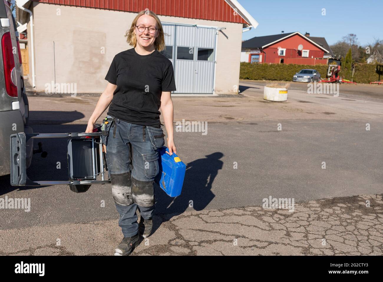 Woman carrying ladder and tools for house renovation Stock Photo - Alamy