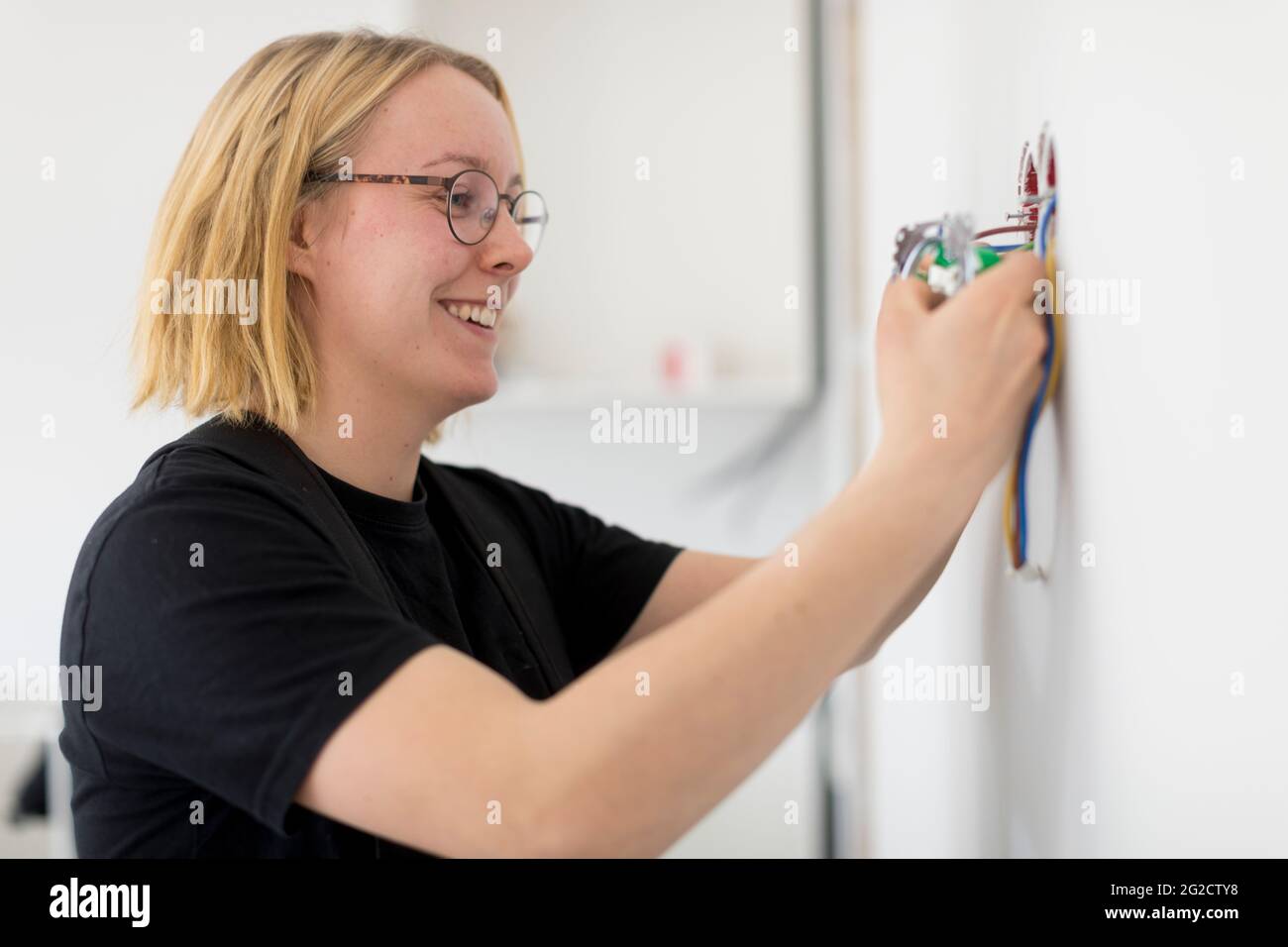Female electrician renovating house Stock Photo - Alamy