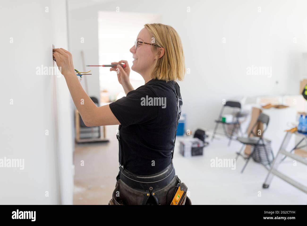 Female electrician renovating house Stock Photo - Alamy