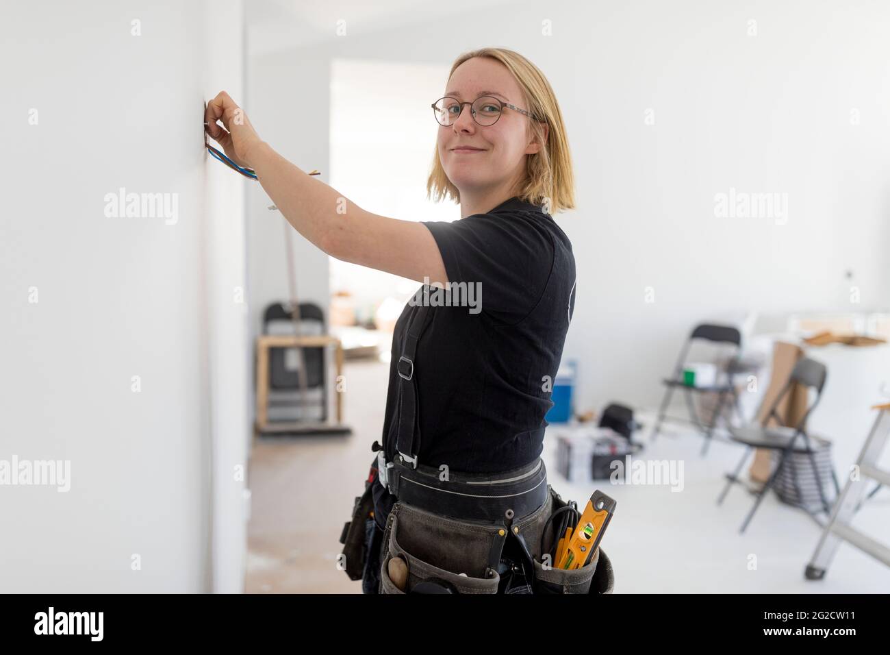 Female electrician renovating house Stock Photo - Alamy
