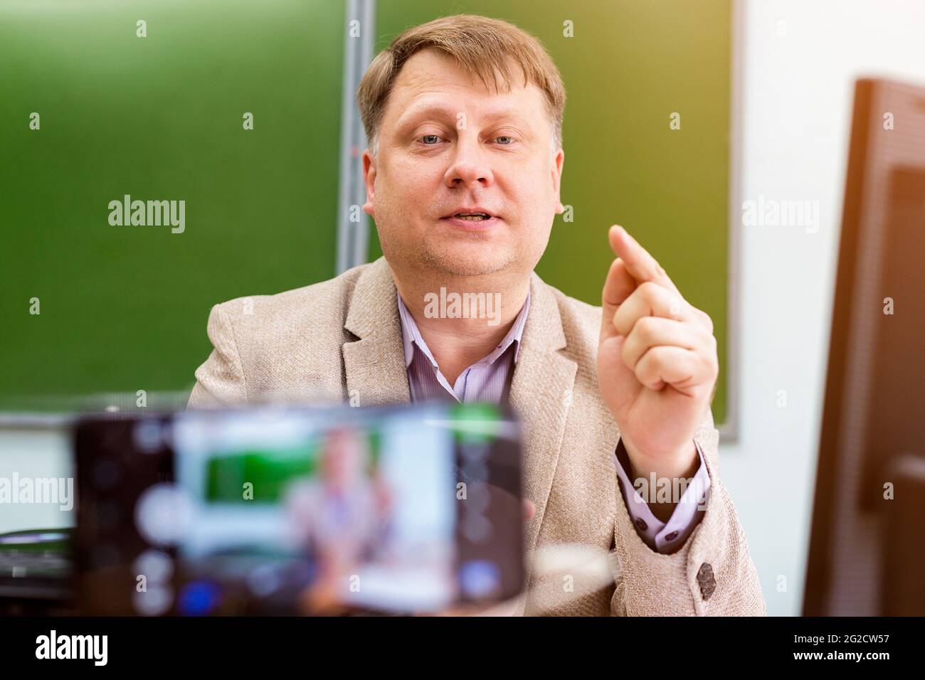 Male teacher conducts online English lesson training Stock Photo - Alamy