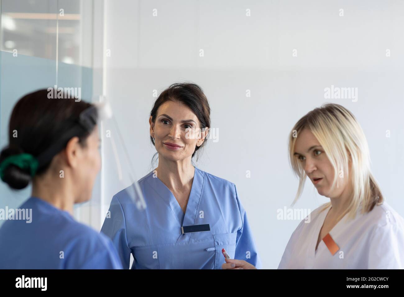 Female nurses and doctor talking Stock Photo - Alamy