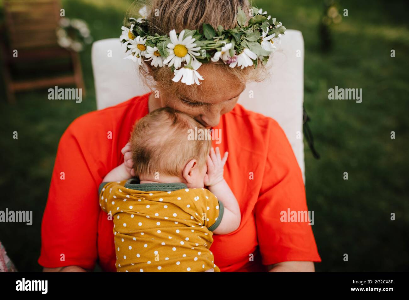 Smiling woman hugging baby Stock Photo - Alamy