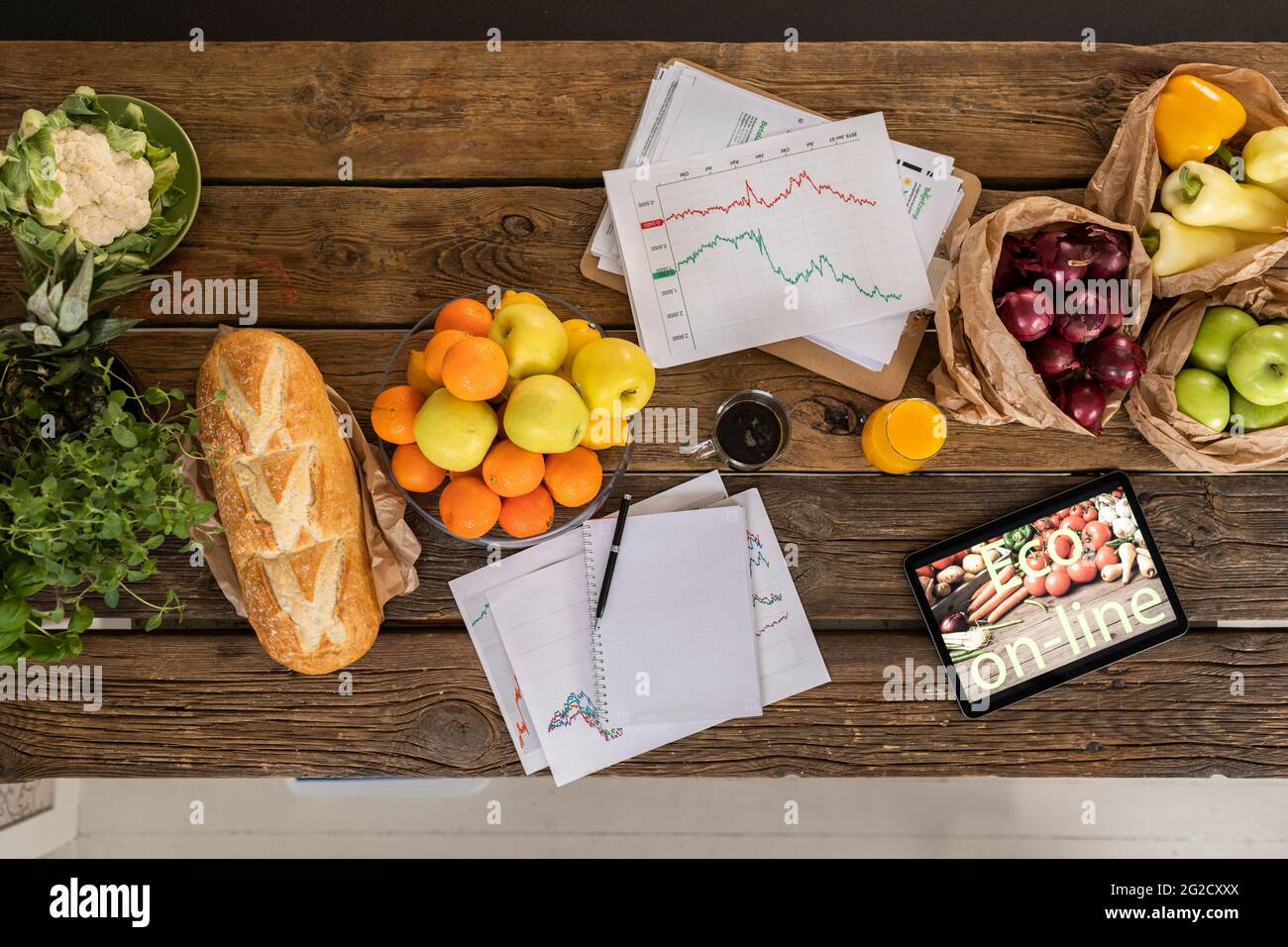 Digital tablet and groceries on kitchen table Stock Photo - Alamy