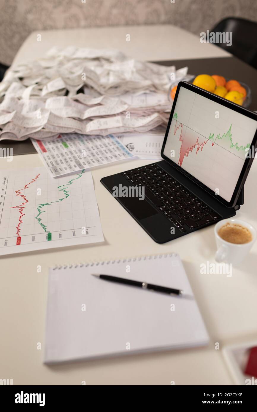 Digital tablet with charts on table Stock Photo - Alamy