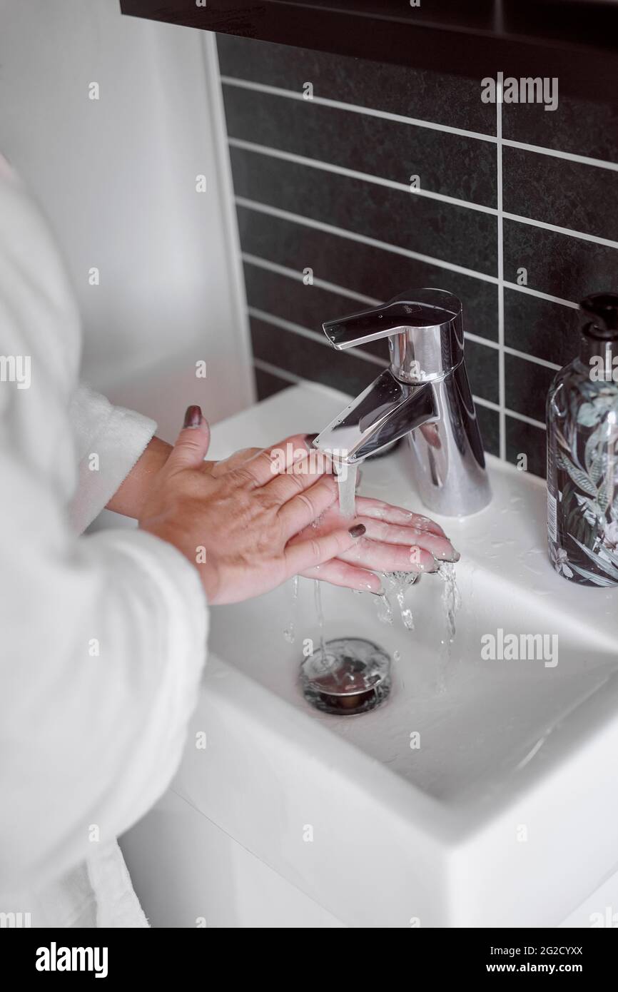 Mid section of woman washing hands Stock Photo - Alamy