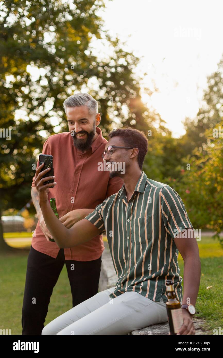 Three male friends standing together hi-res stock photography and ...