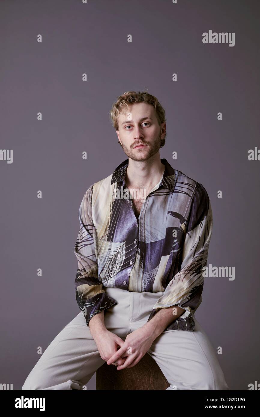 Serious man sitting studio background hi-res stock photography and ...