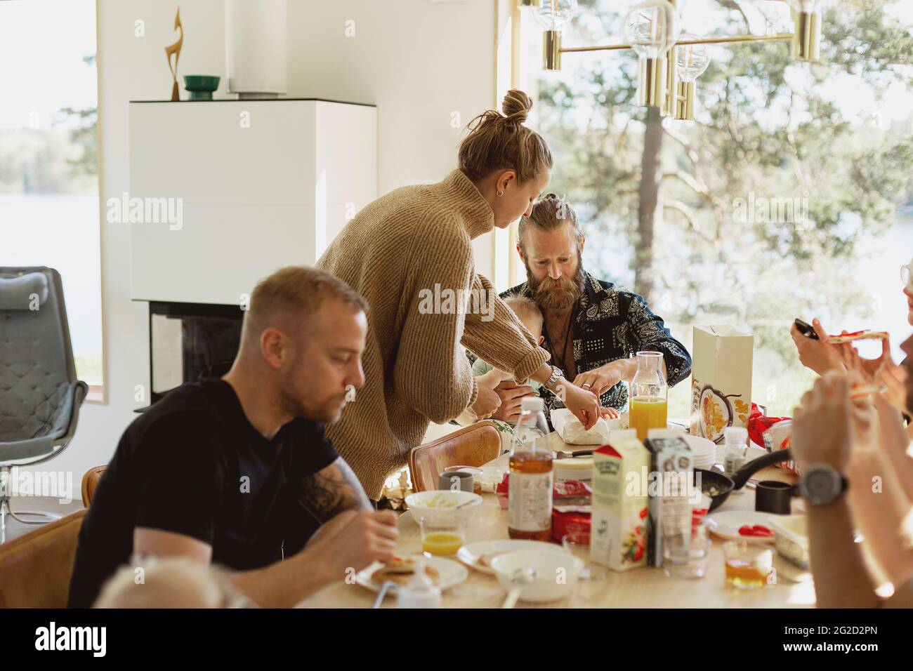 Group of friends eating breakfast Stock Photo - Alamy
