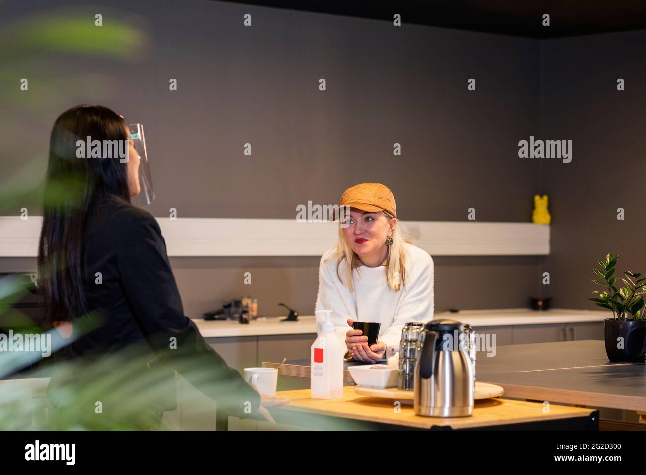 Women talking in office kitchen Stock Photo - Alamy