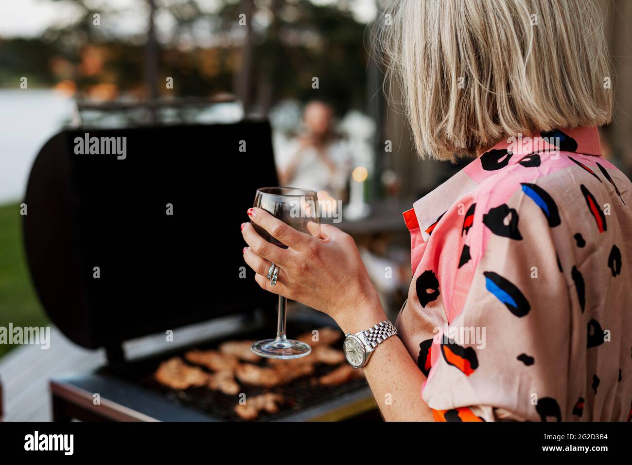 Woman barbecuing meat hi-res stock photography and images - Alamy