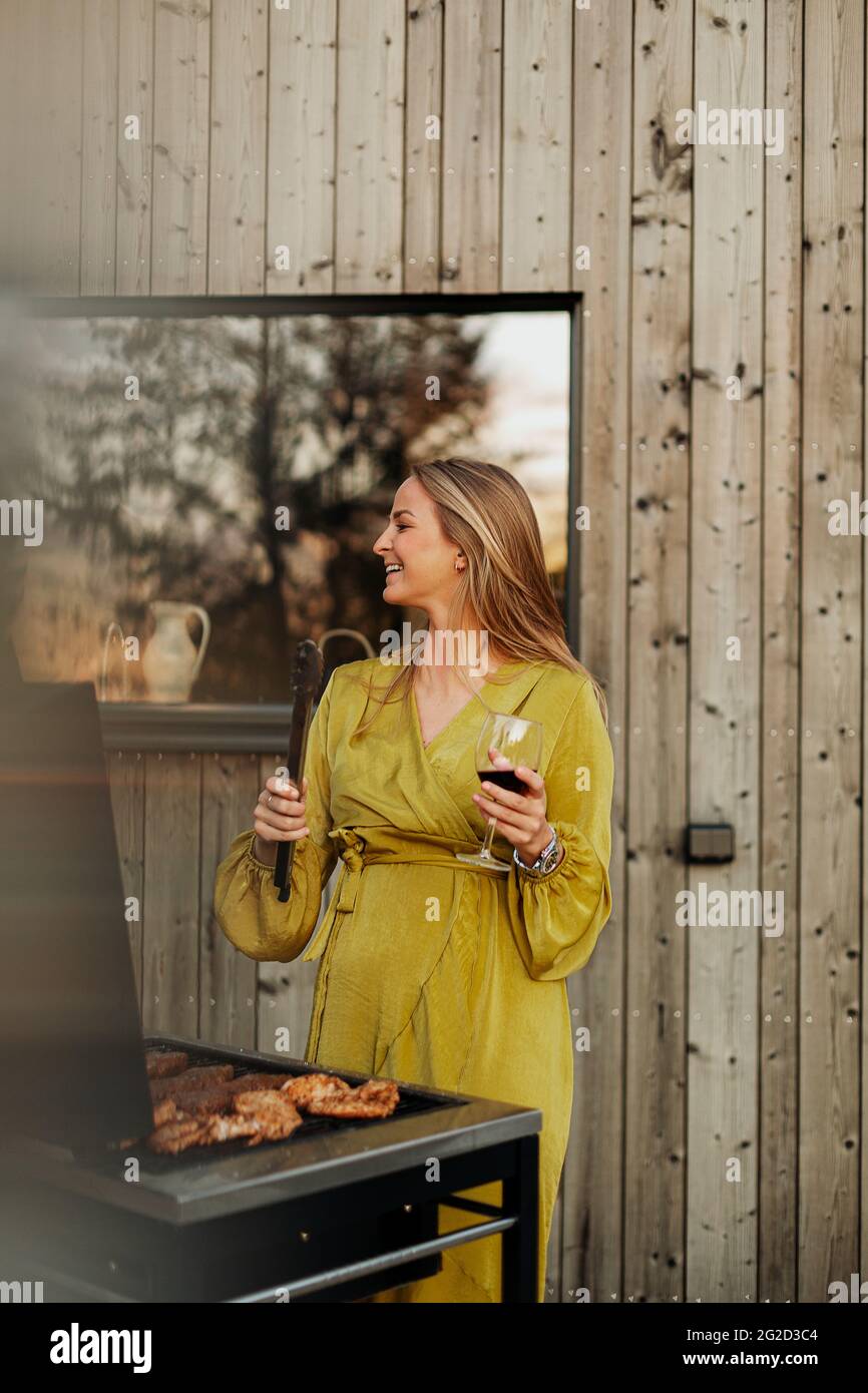 Woman barbecuing meat hi-res stock photography and images - Alamy