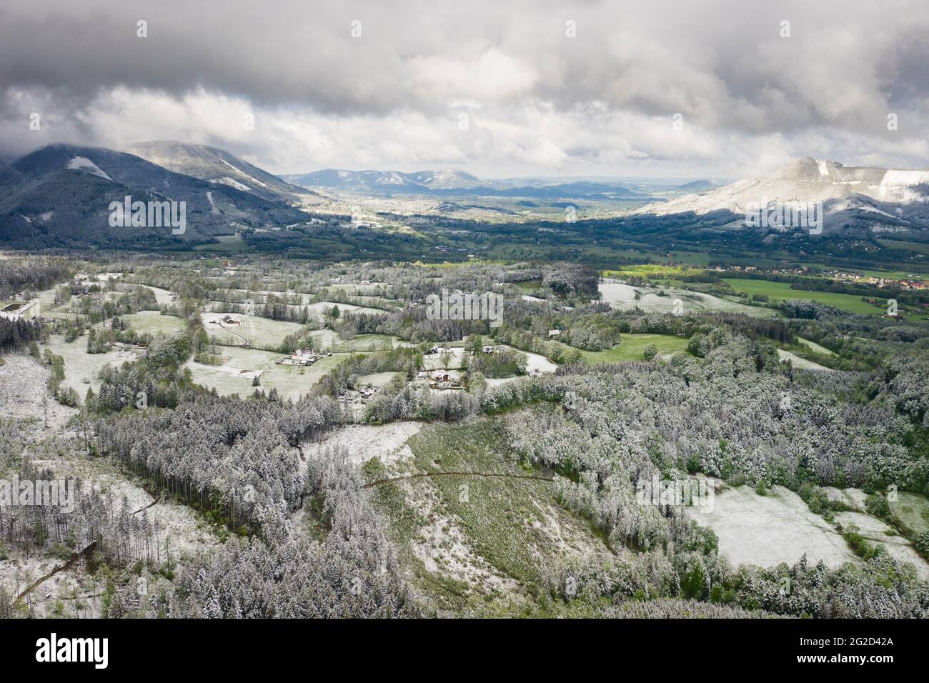 Mountains in the Czech Republic in spring with green fields and snow in ...