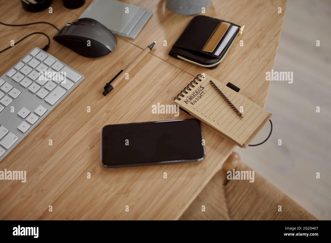 Notepad and cell phone on desk Stock Photo - Alamy