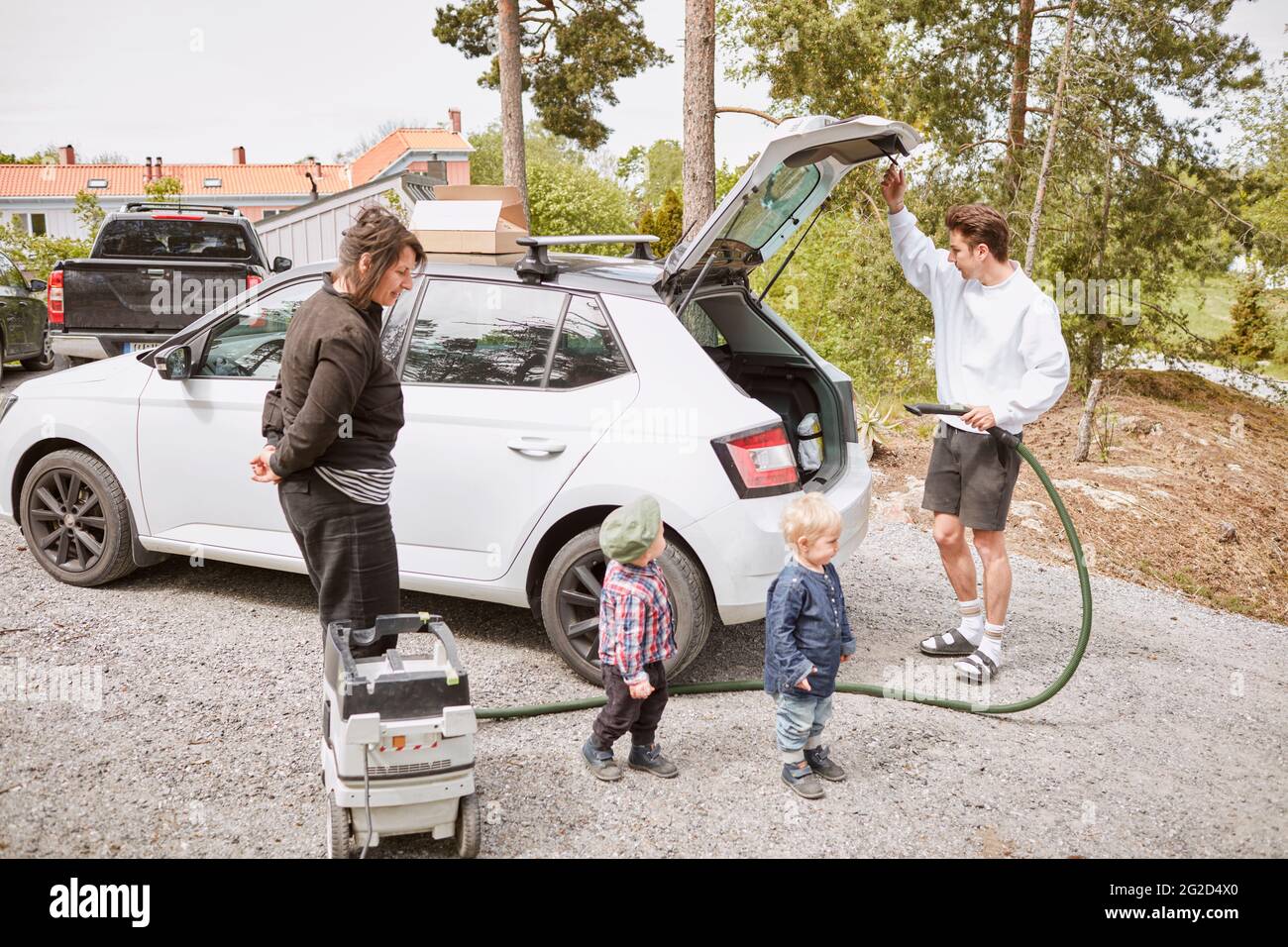 Man vacuuming car boot Stock Photo - Alamy