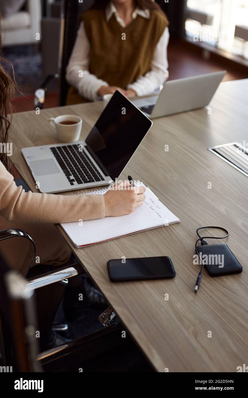 Woman taking notes during phone hi-res stock photography and images - Alamy