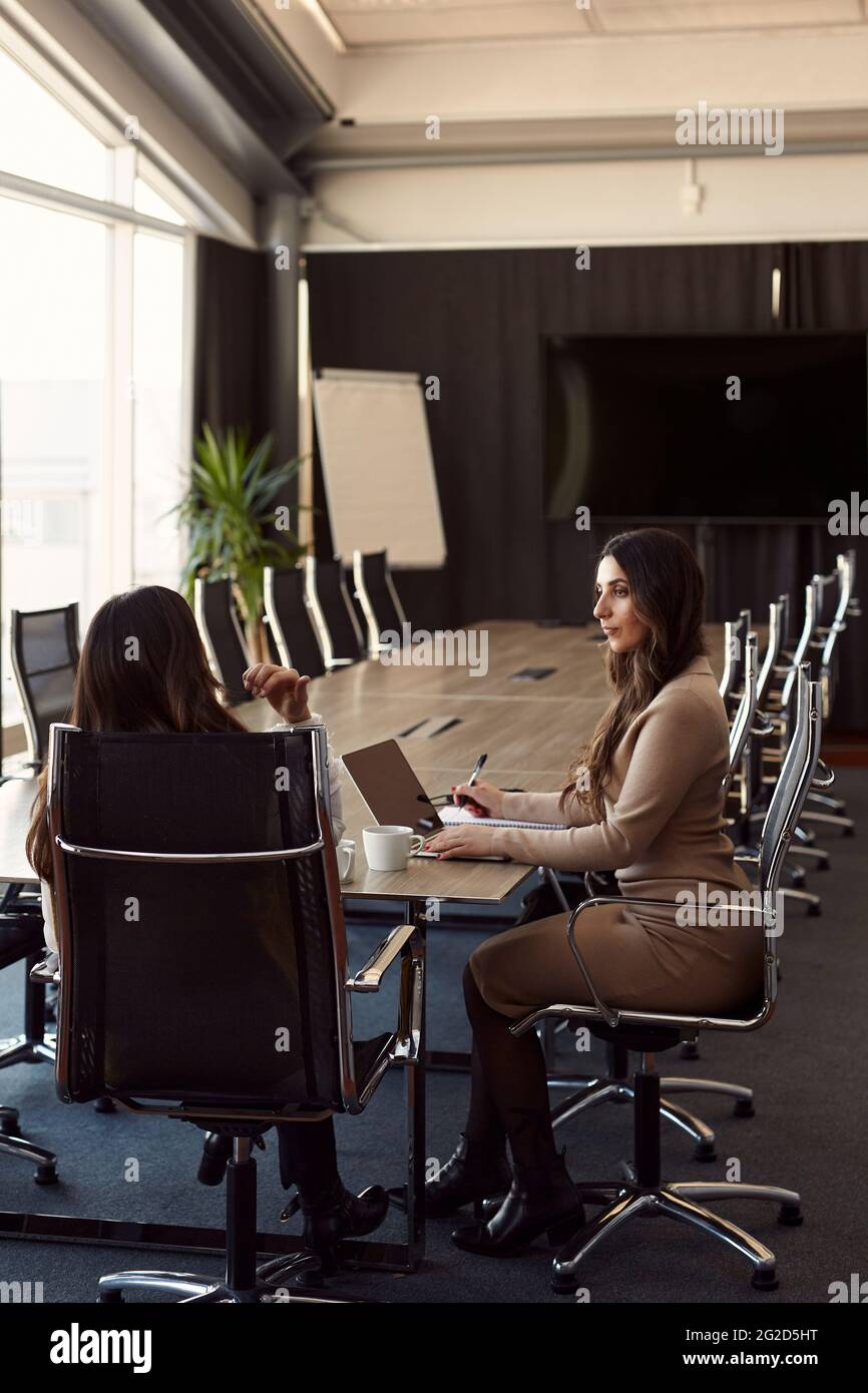 Two young women in boardroom hi-res stock photography and images - Alamy