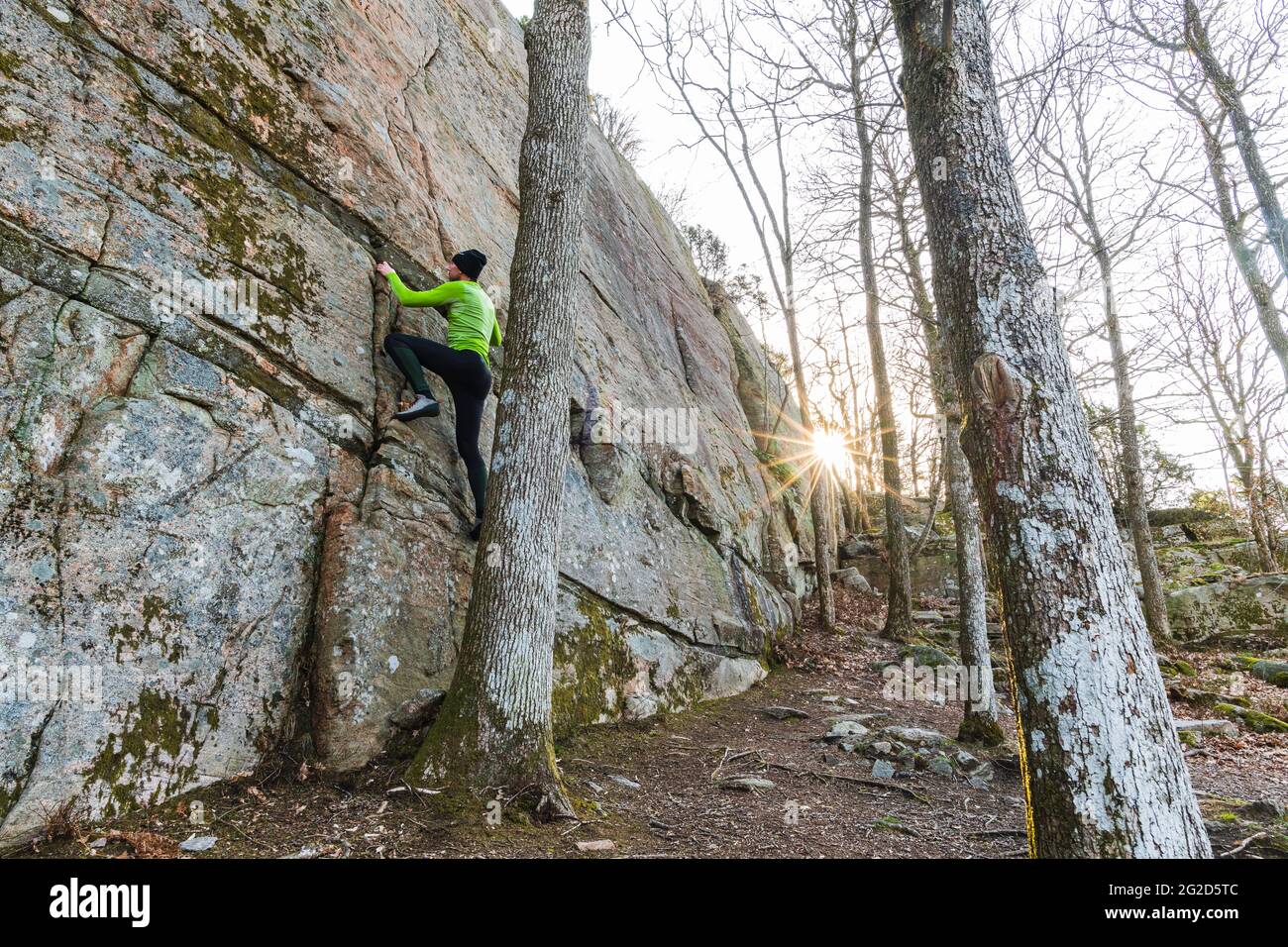 Person climbing rock formation hi-res stock photography and images - Alamy