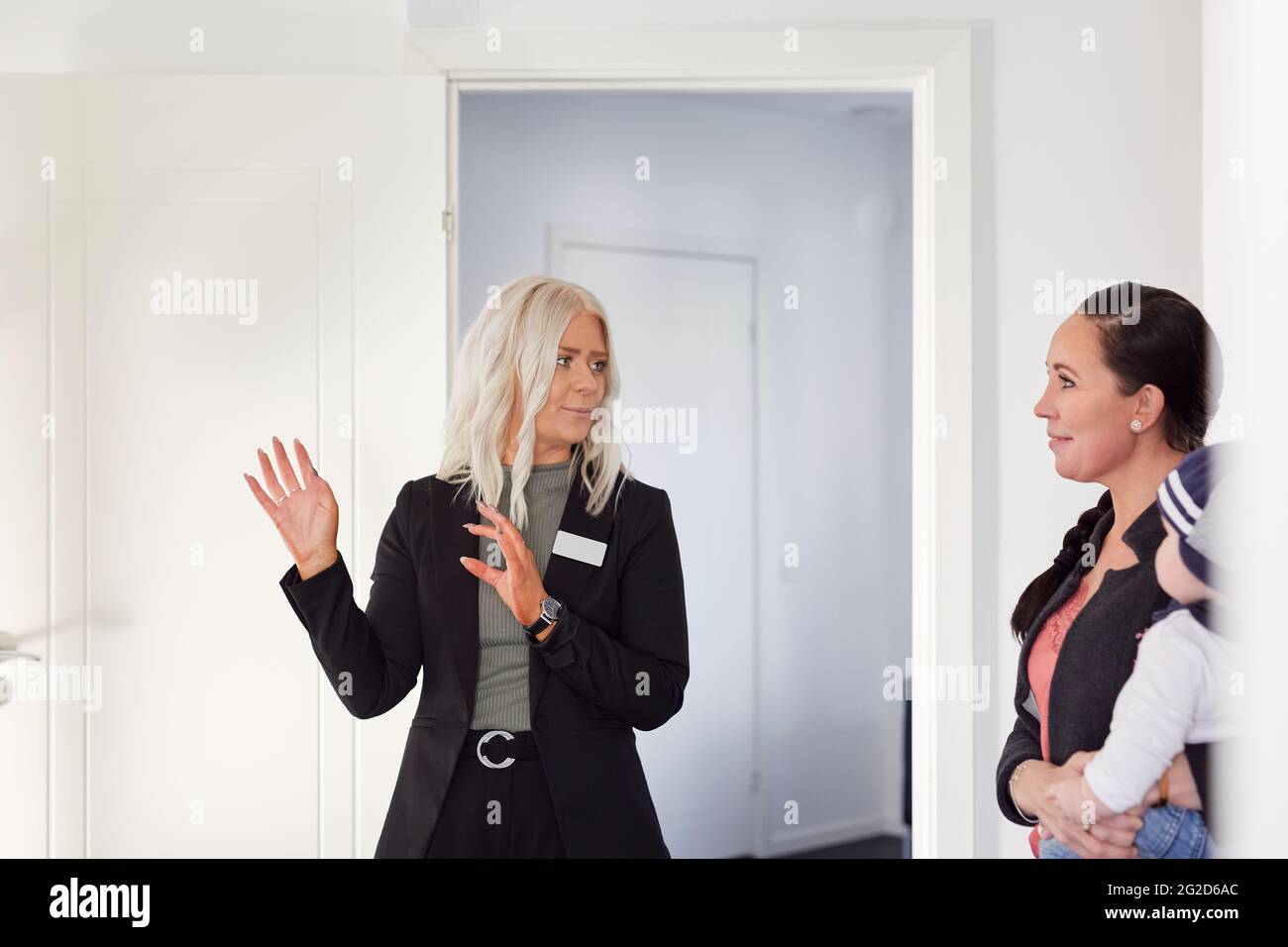 Estate agent showing client house Stock Photo - Alamy