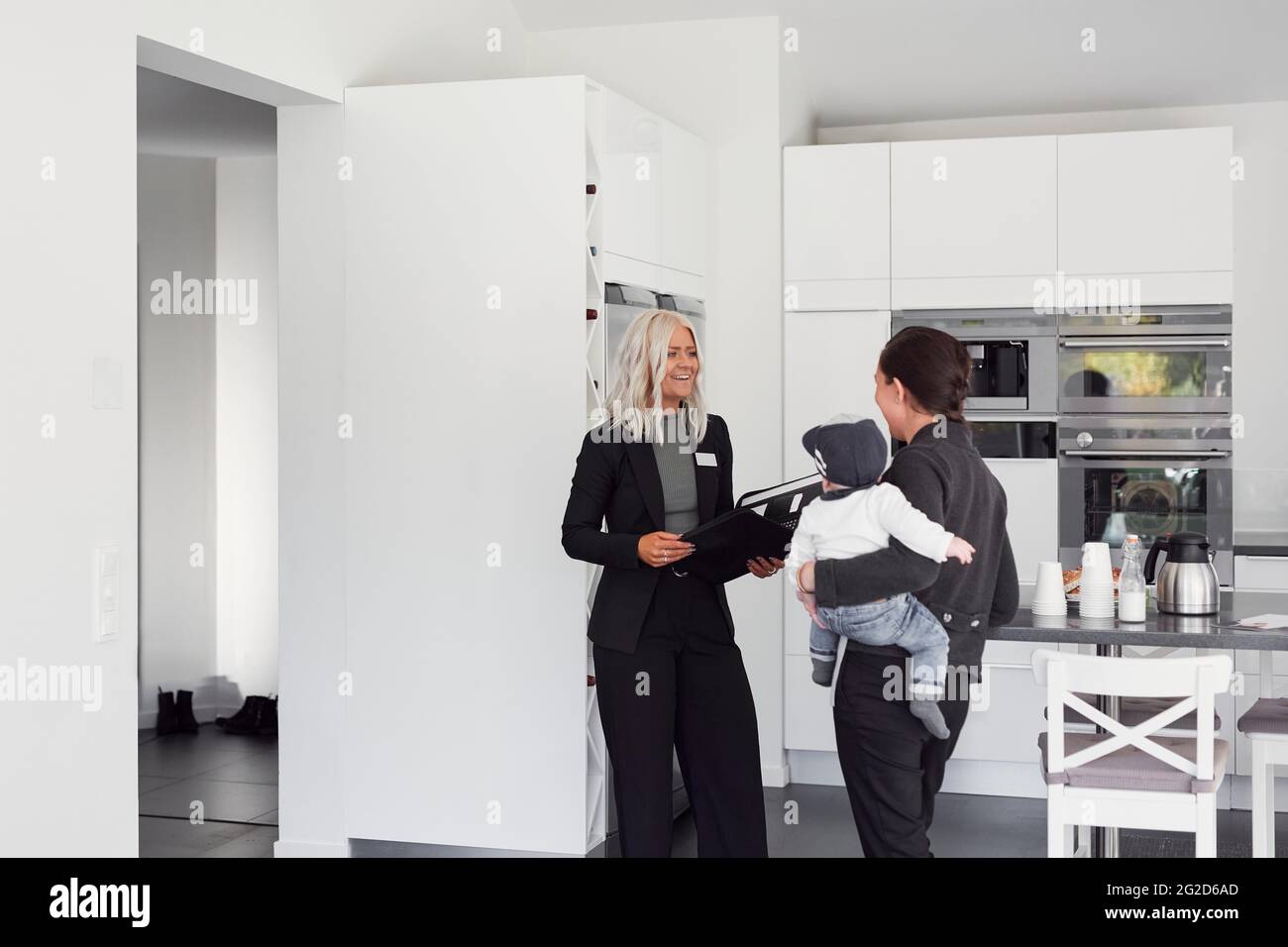 Estate agent talking to client Stock Photo - Alamy