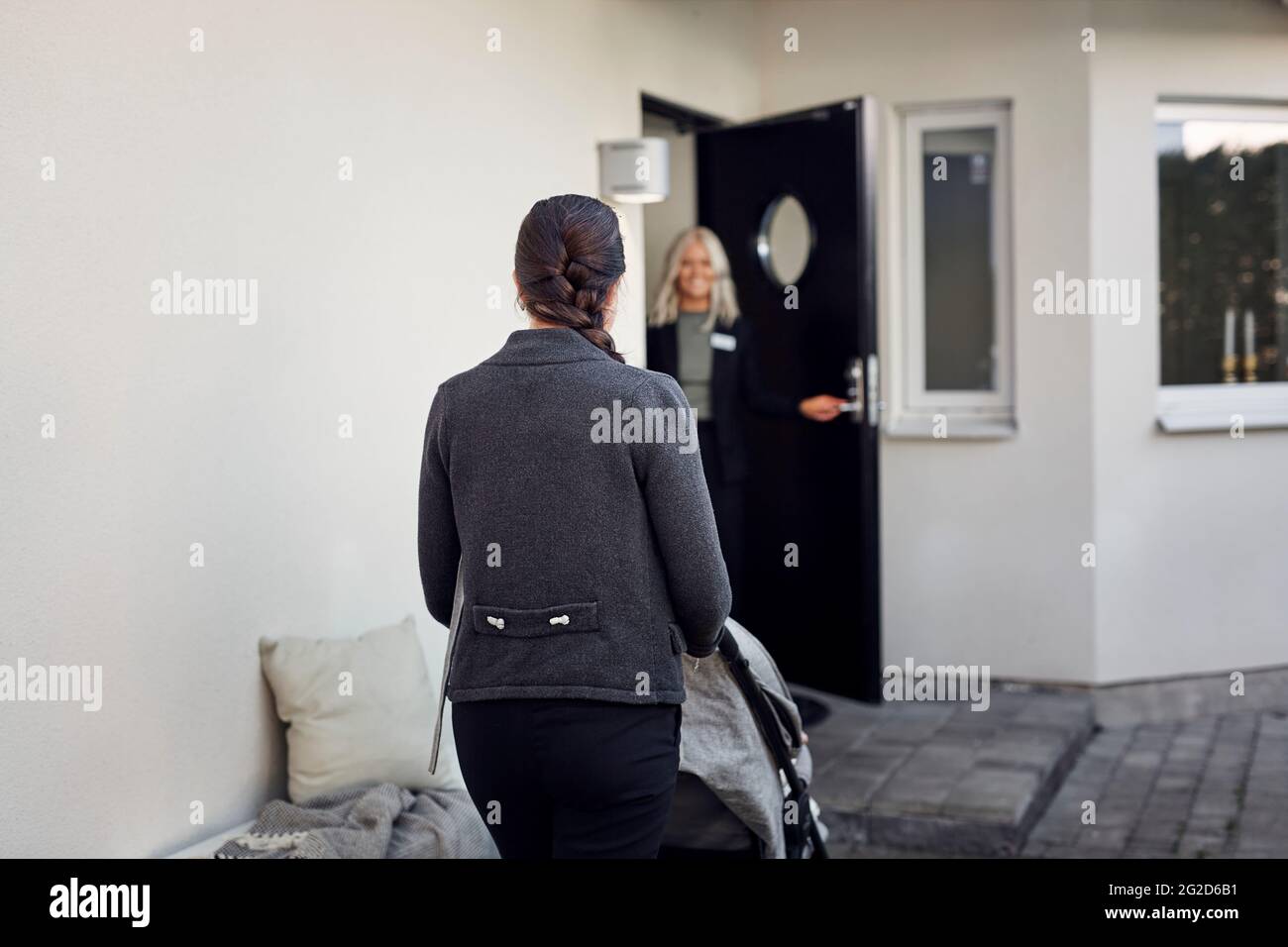 Woman in front of house hi-res stock photography and images - Alamy