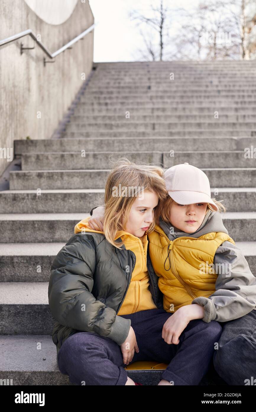 Two sisters sitting on stairs hi-res stock photography and images - Alamy
