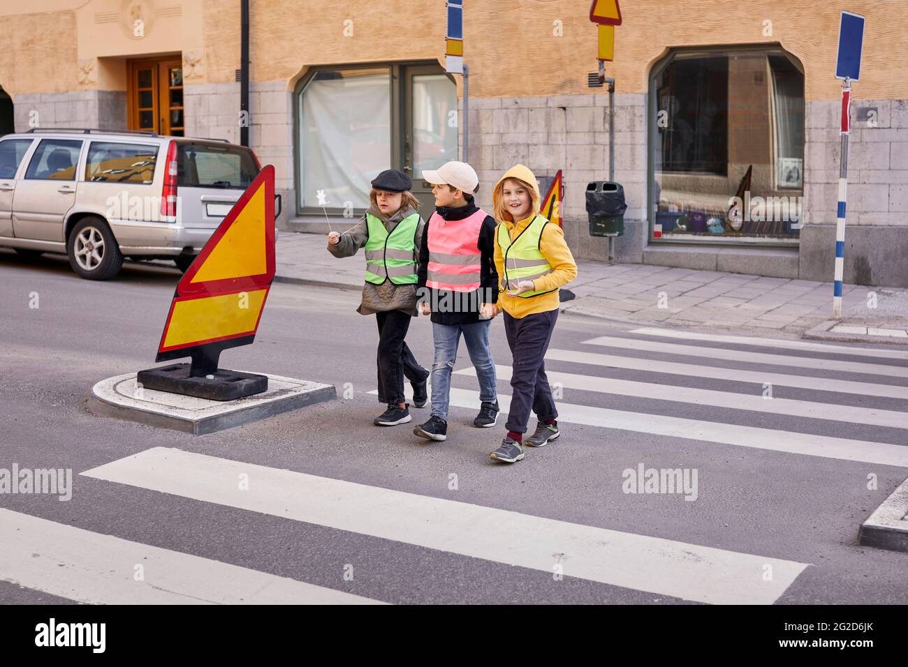 Children crossing road together Stock Photo - Alamy