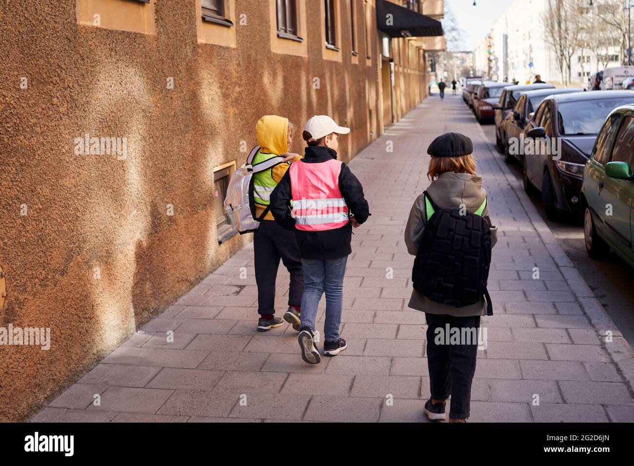 Rear view of children walking Stock Photo - Alamy