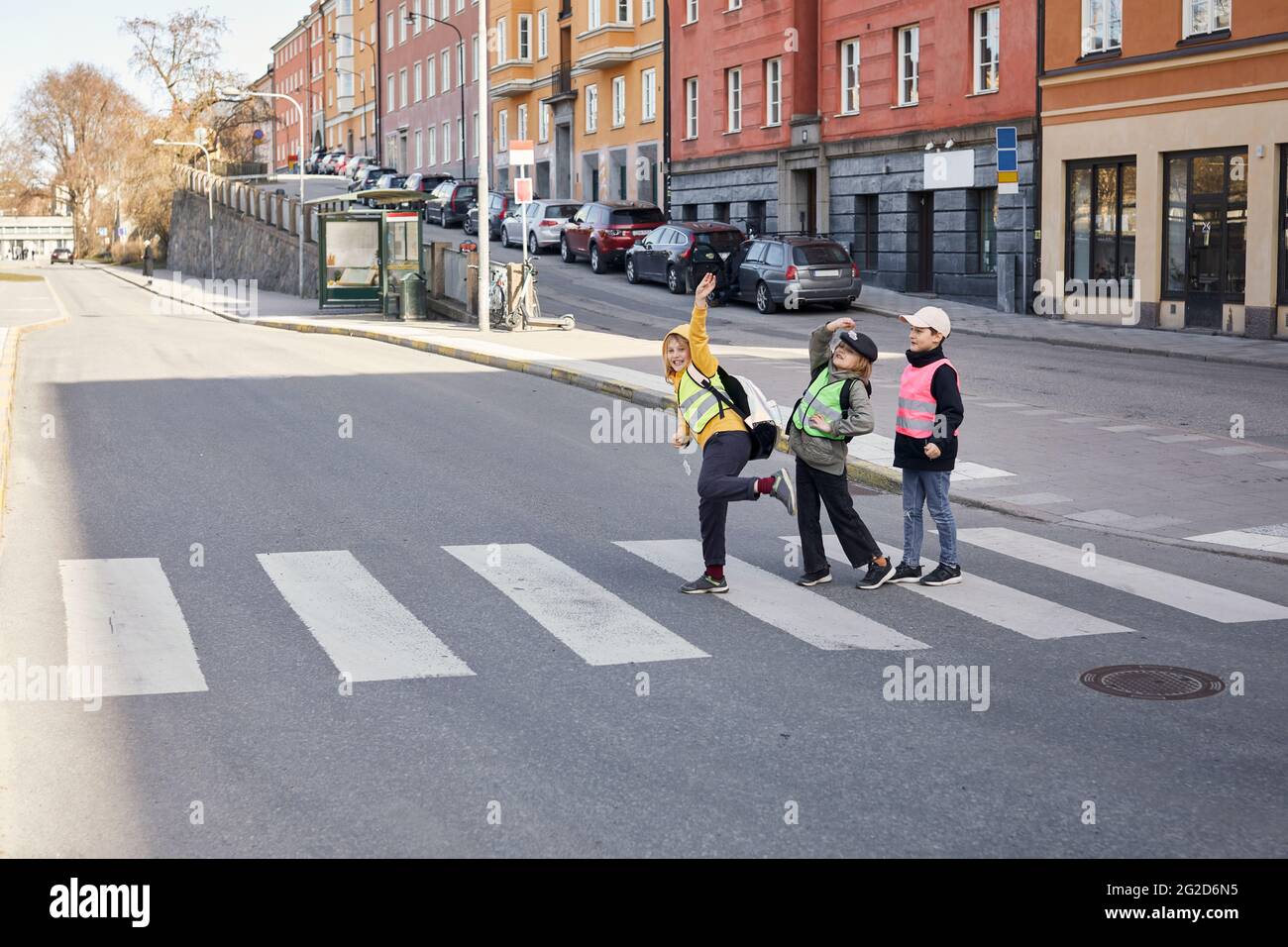 Children crossing road together Stock Photo - Alamy