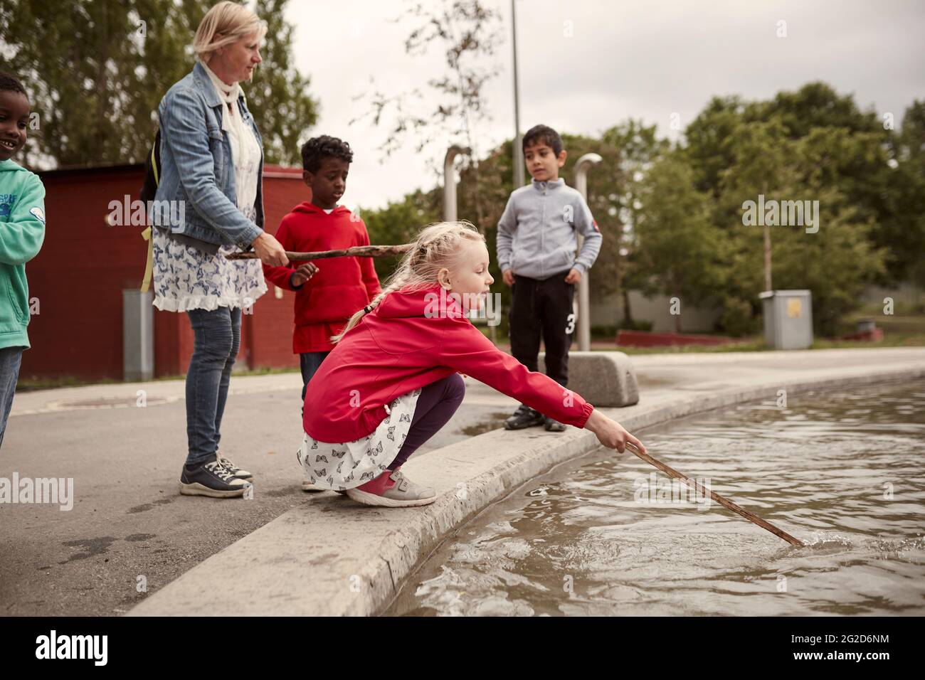 Adult playing stick in water hi-res stock photography and images - Alamy