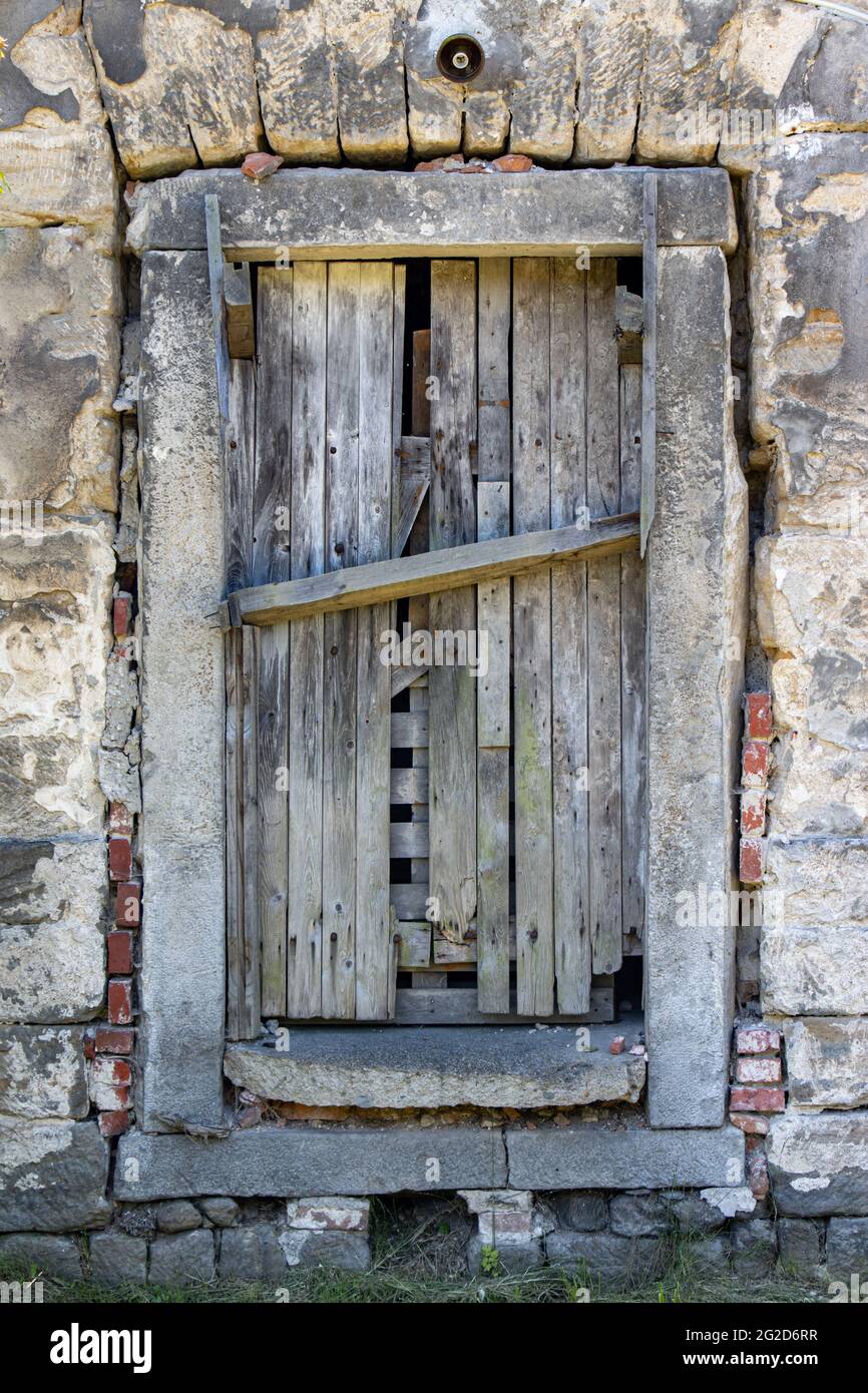 A damaged door in an abandoned building Stock Photo - Alamy