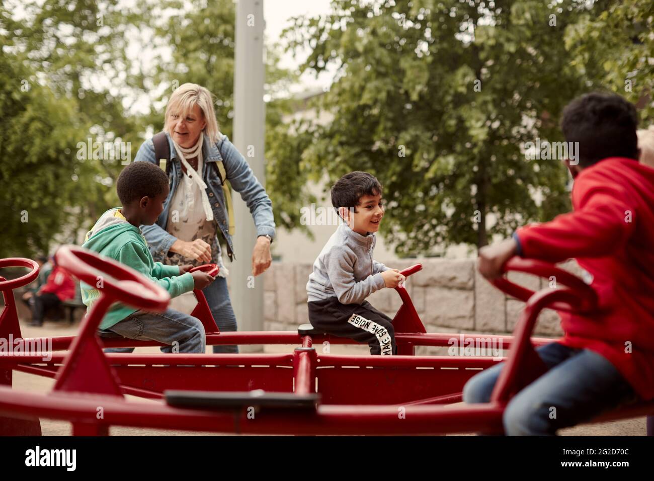 Children spinning on merry go round Stock Photo - Alamy