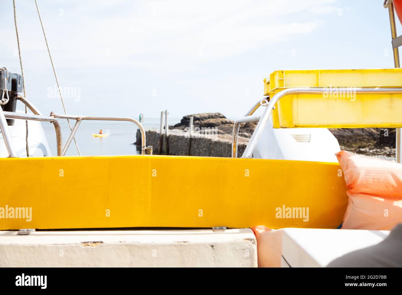 view over the stern of the yellow coloured Ynys Enlli / Bardsey Island ...