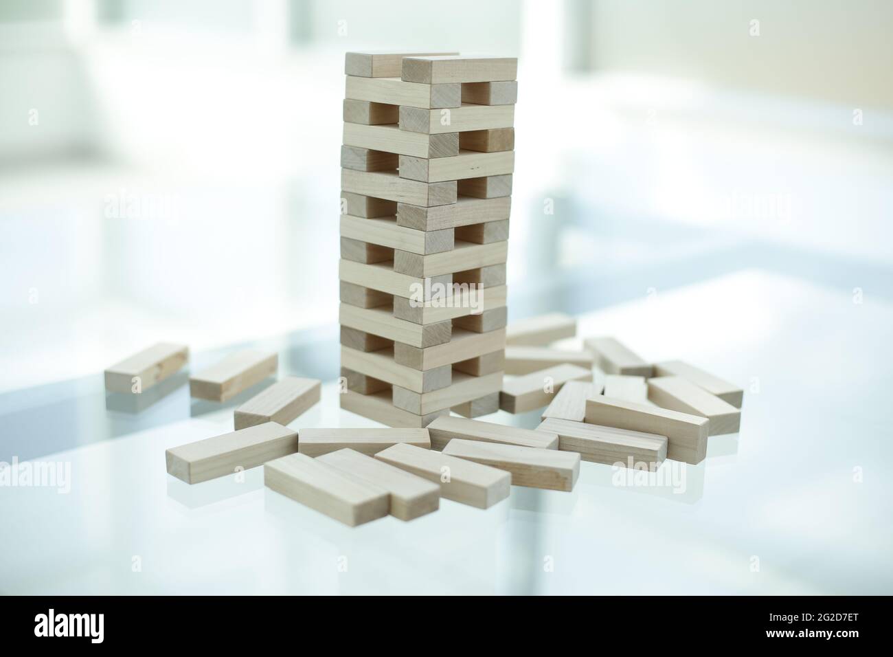 Wood Jenga on glass table Stock Photo - Alamy