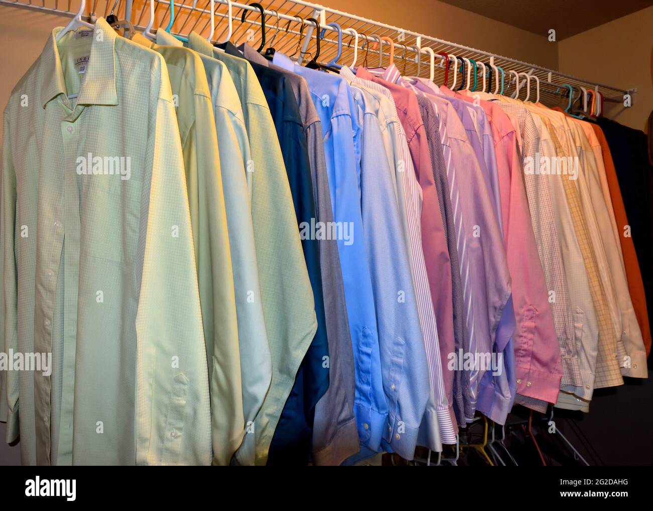 Colorfully aligned dress shirts hanging in a closet Stock Photo - Alamy