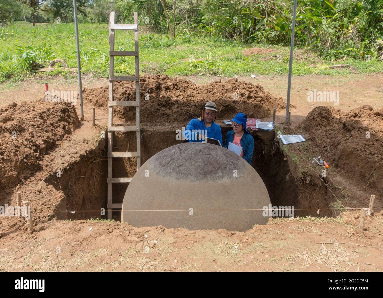 Archaeologists from the National Museum of Costs Rica investigating a ...